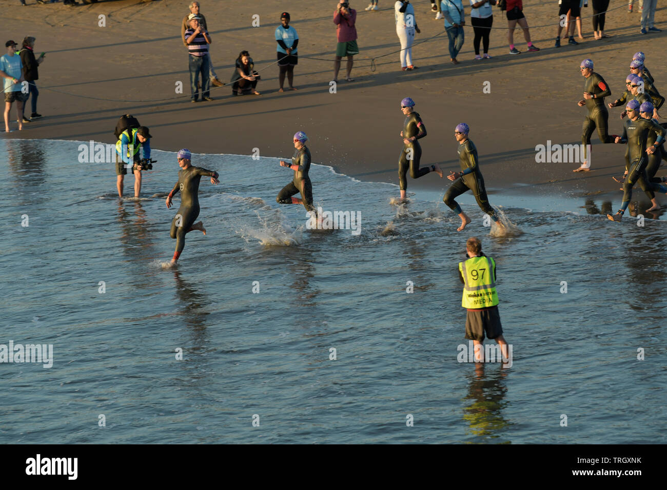 Elite triathletes running into water, start swimming leg, 2019, Ironman ...