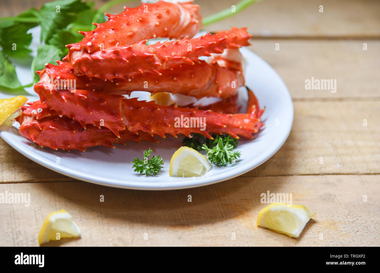 Alaskan King Crab Legs cooked seafood with lemon spices on white plate ...
