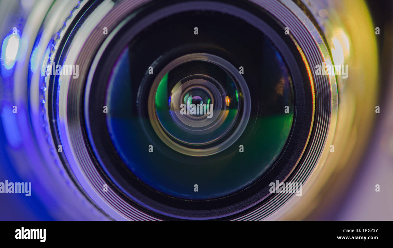 The camera lens and the beautiful multi-colored light blue and yellow ...