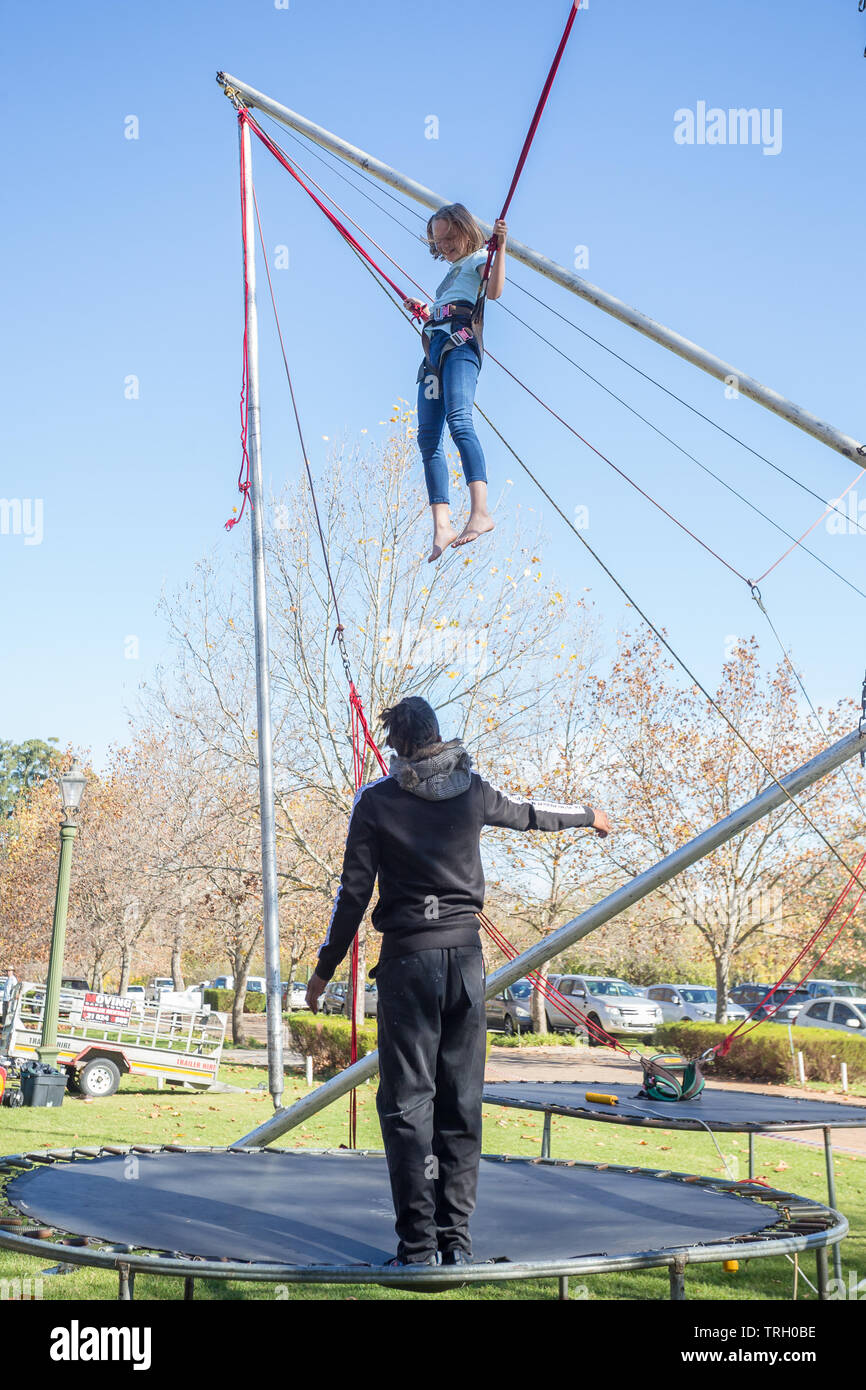 young caucasian girl or child suspended in mid air on a trampoline with ...