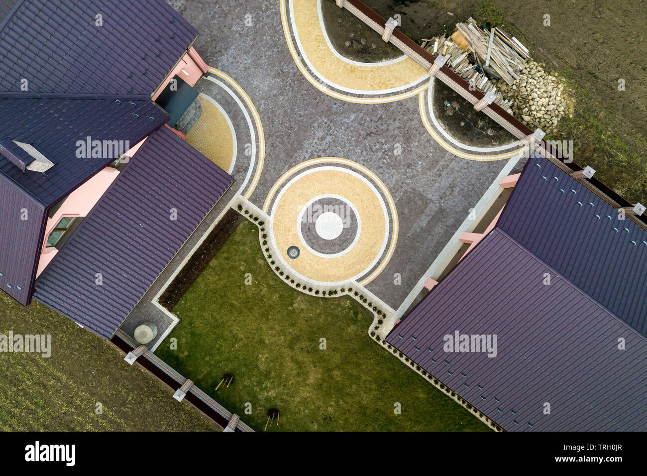 Aerial top view of house shingle roof on background of green lawn and ...