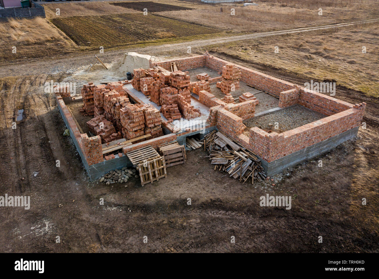 Aerial view of building site. Trenches dug in ground and filled with ...