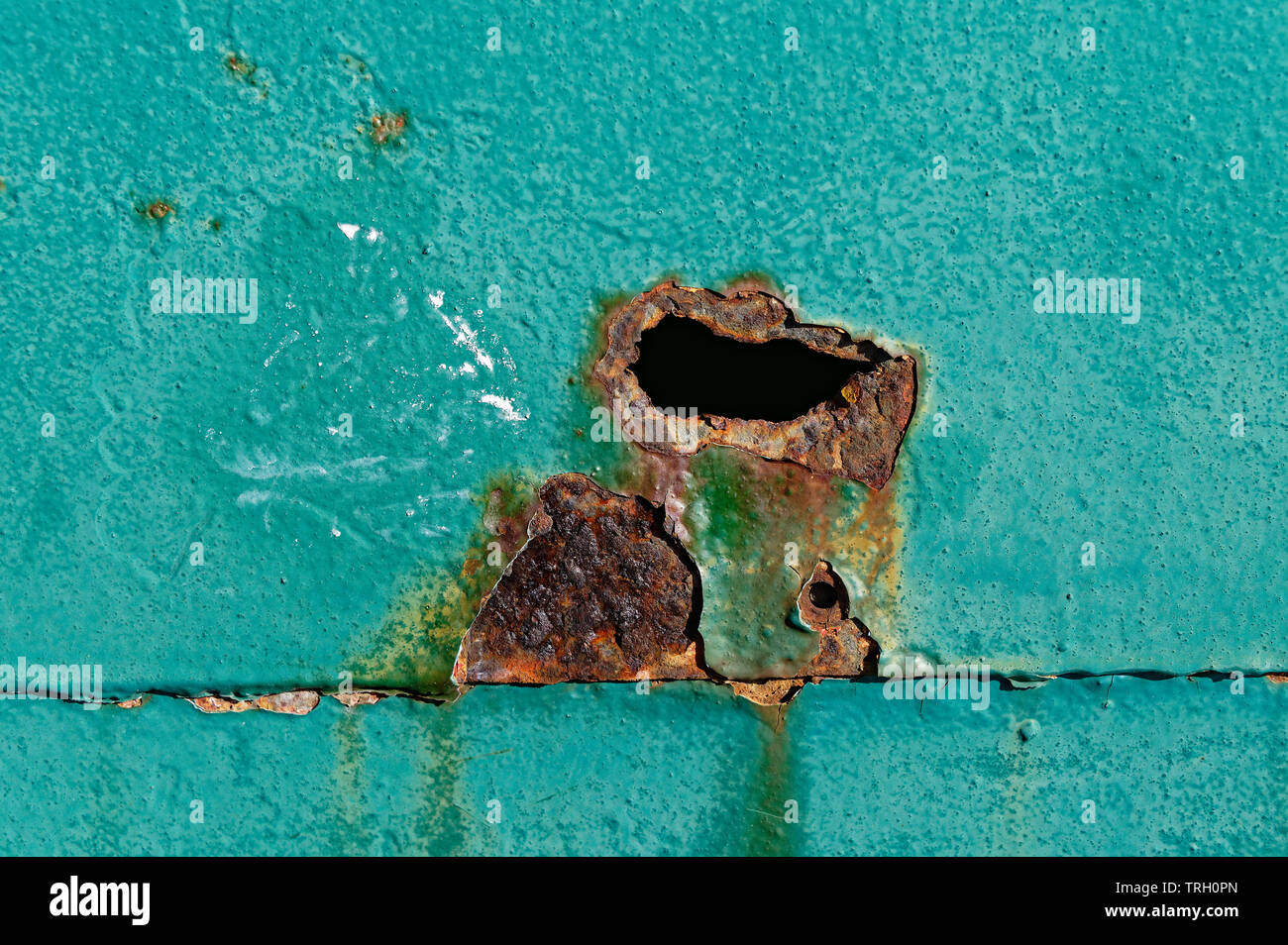 Rust has eaten through a metal door causing a hole Stock Photo - Alamy
