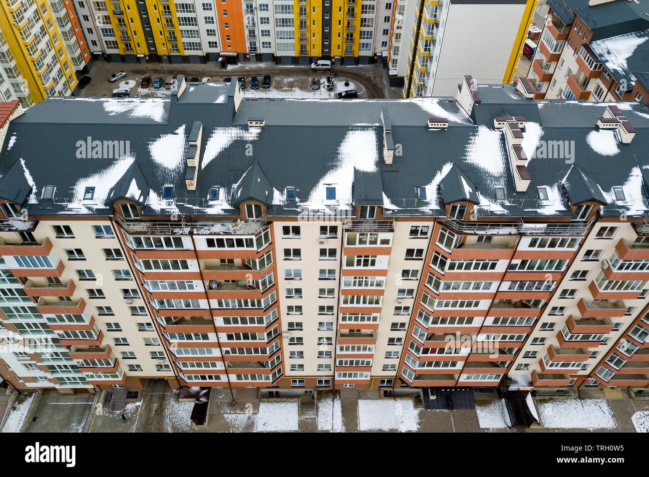 Aerial winter top view of tall apartment building, brick chimneys ...