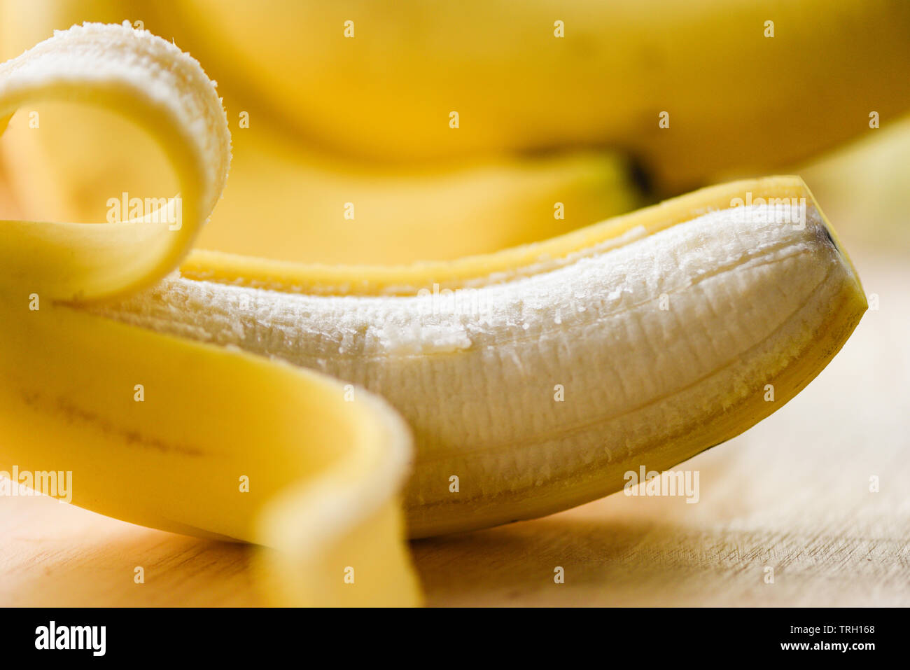 Banana peel / Close up od fresh ripe a banana fruit peeled on wooden ...
