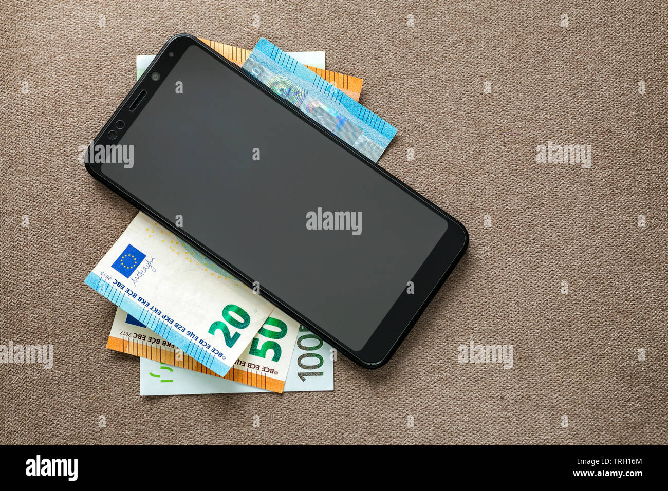New black modern digital cellphone on money euro banknotes on copy ...