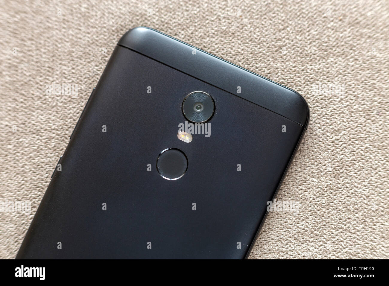 Back side of black cellphone isolated with security thumb fingerprint ...