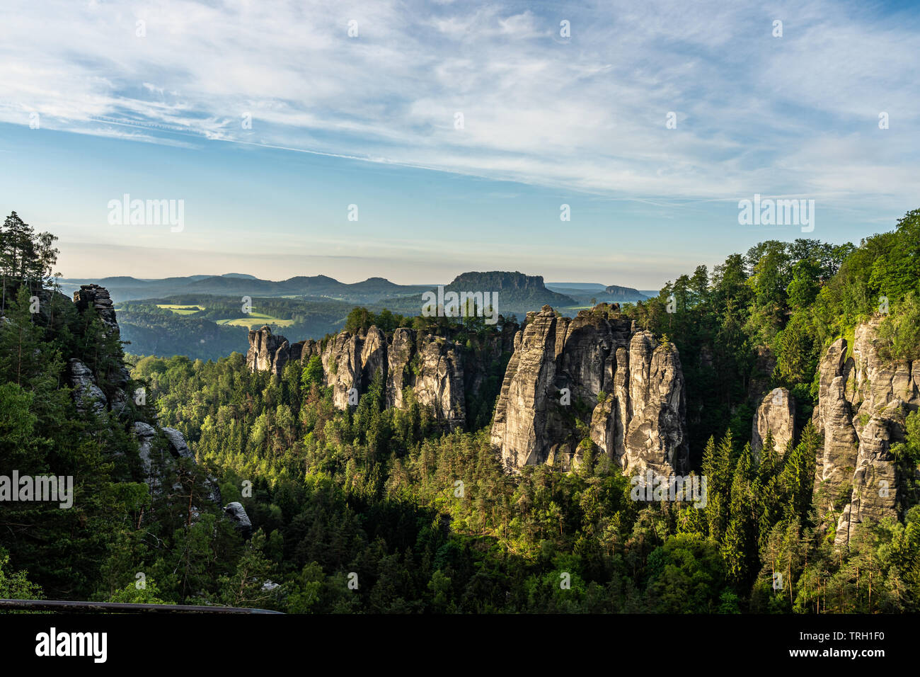 view on sandstone rocks and mountains at sunrise in saxon switzerland ...