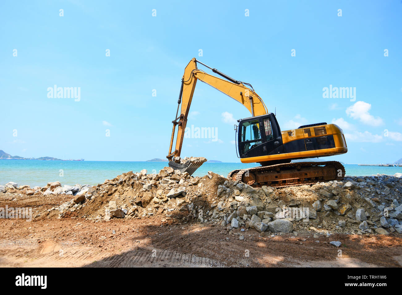 excavator digger stone working on construction site / backhoe loader on ...
