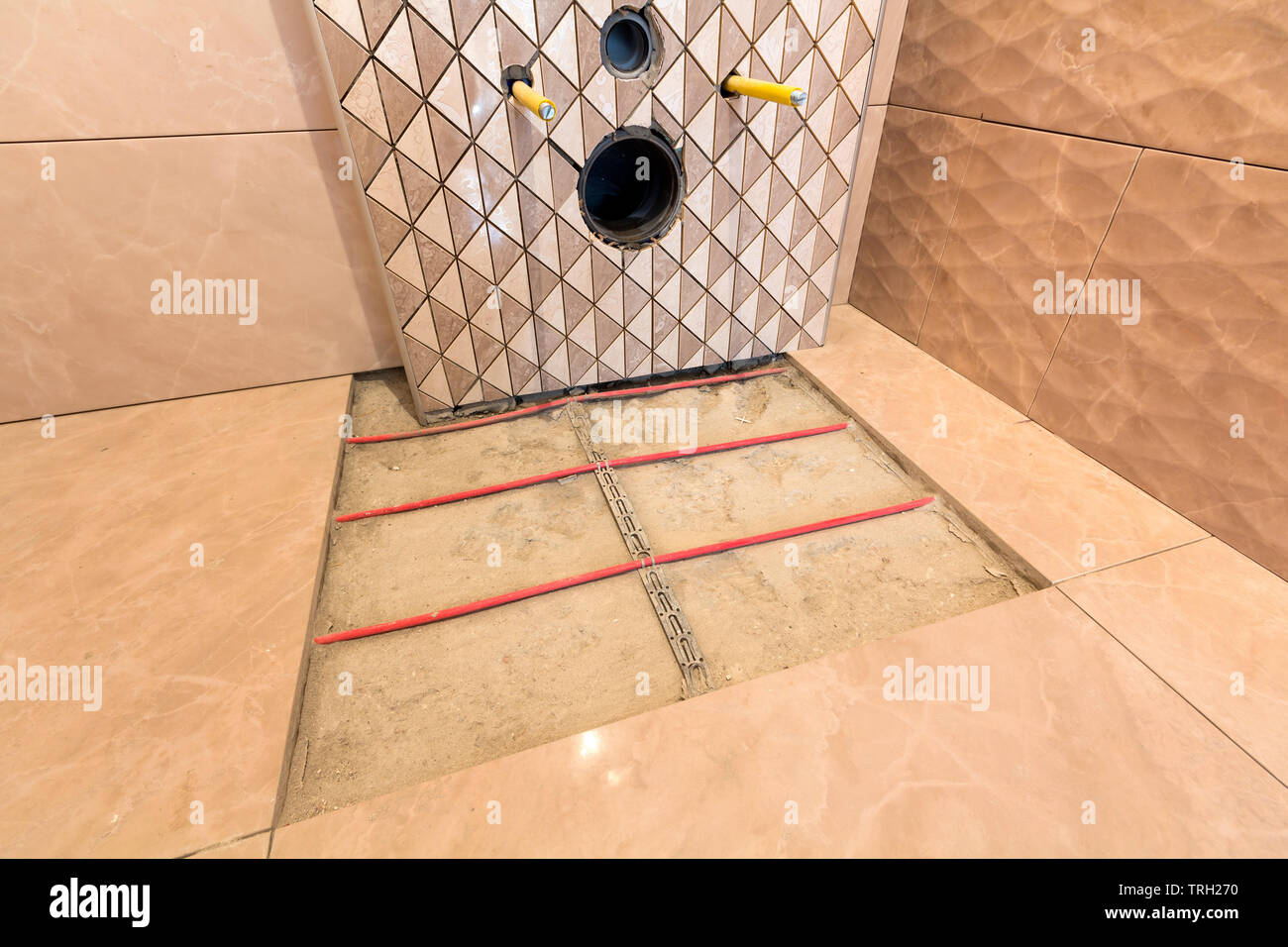 Unfinished reconstruction of bathroom with ceramic tiles installed on ...