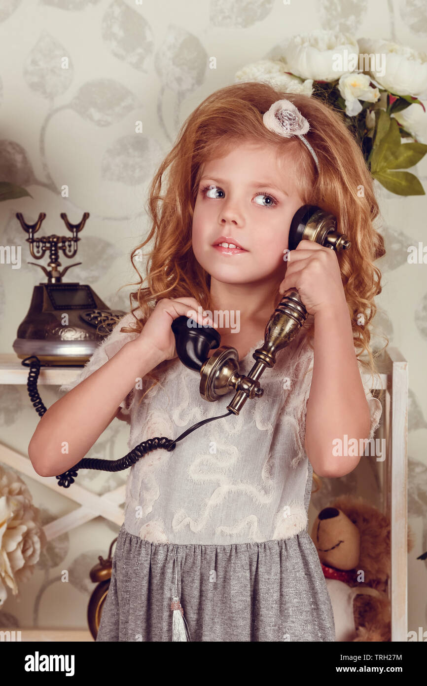 Cute little child girl with spring flowers, happy baby girl with basket ...