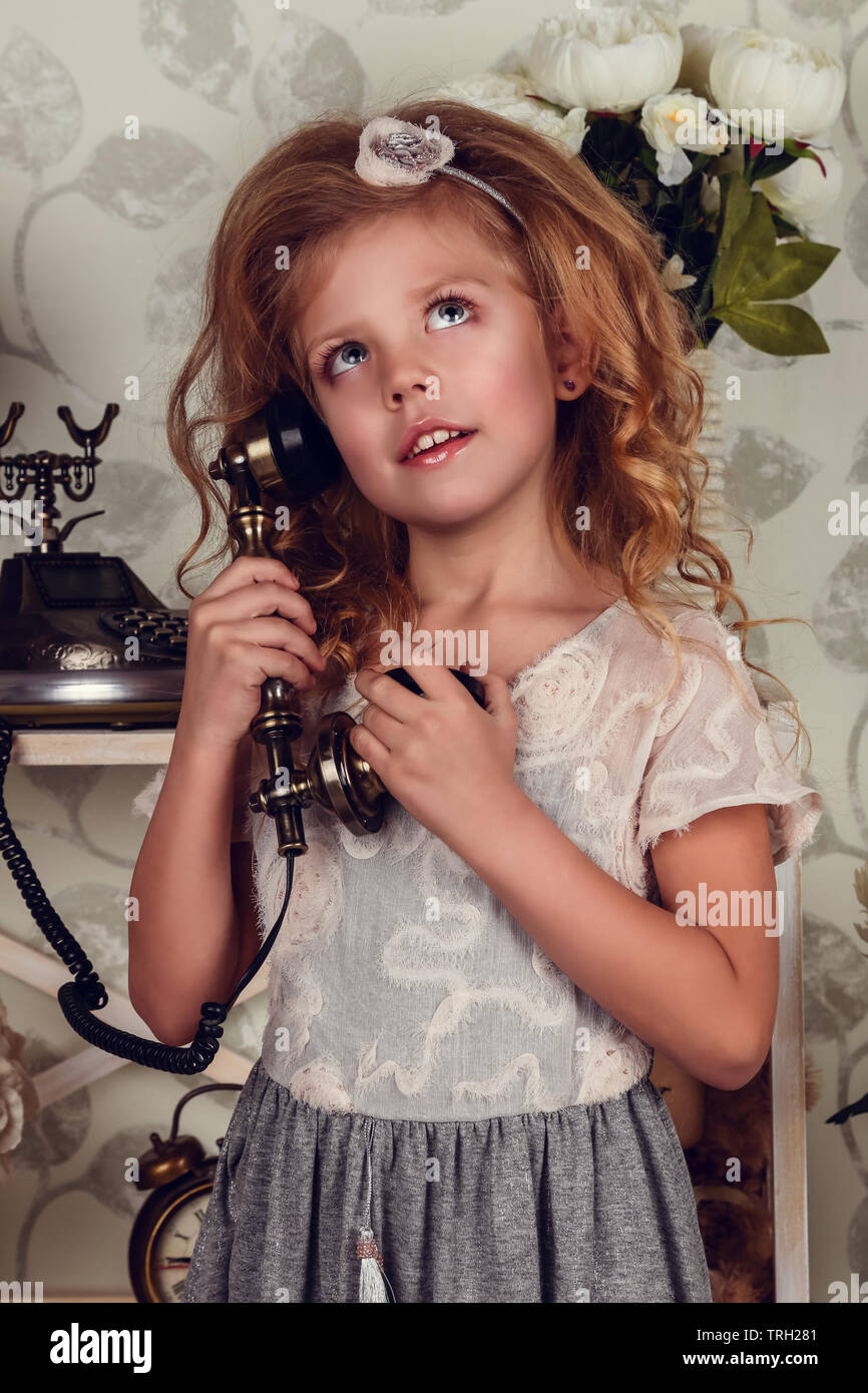 Cute little child girl with spring flowers, happy baby girl with basket ...