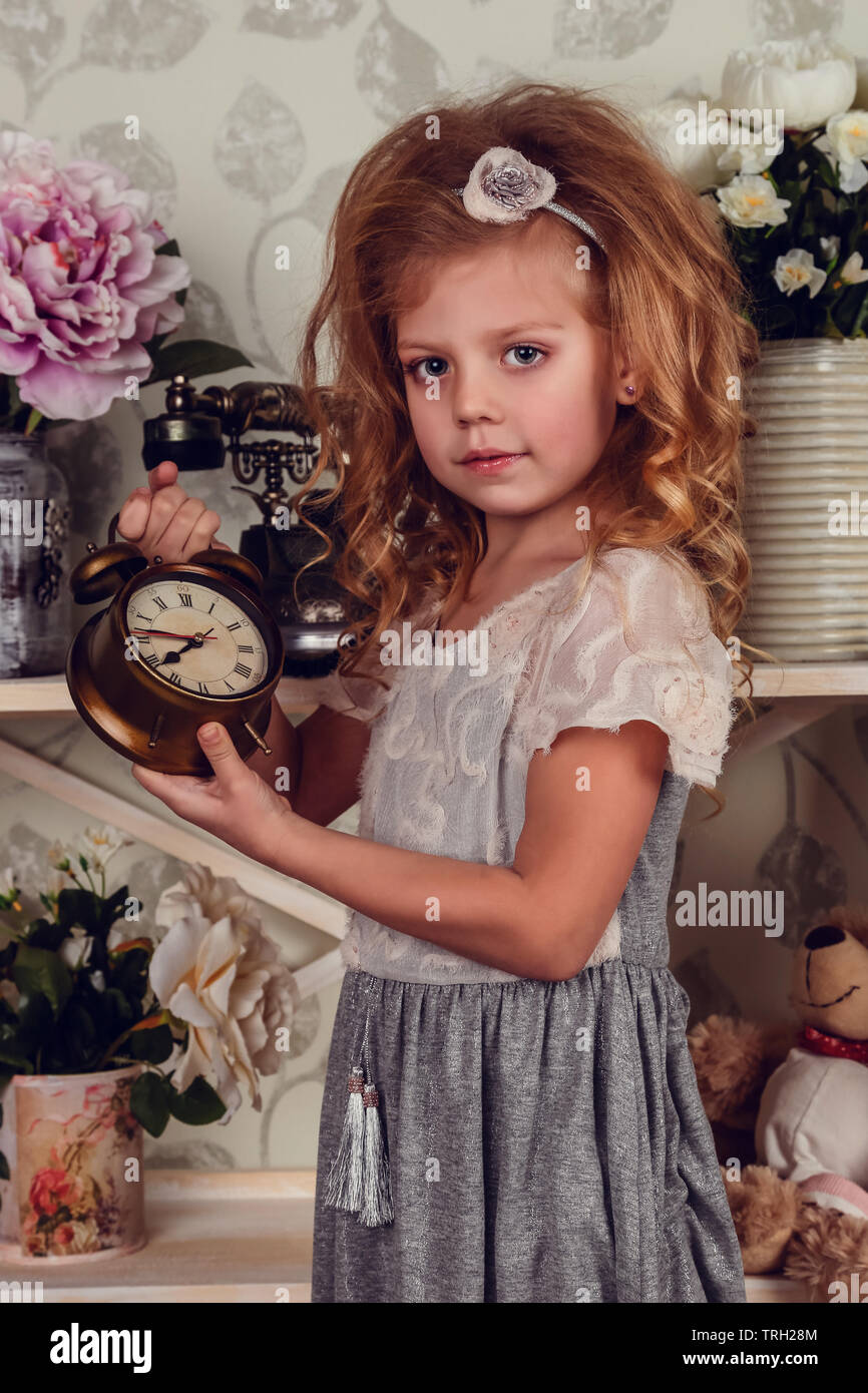 Cute little child girl with spring flowers, happy baby girl with basket ...