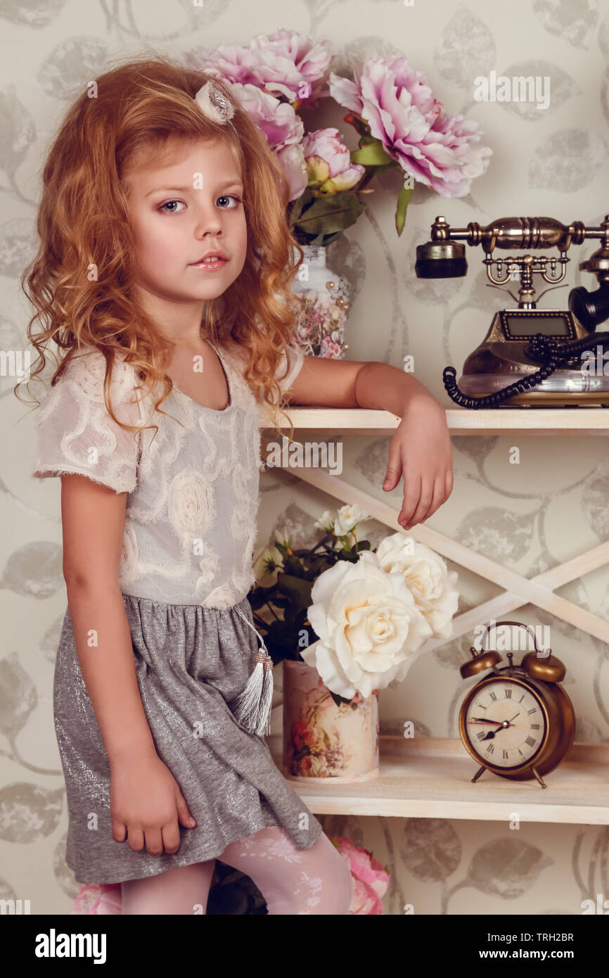 Cute little child girl with spring flowers, happy baby girl with basket ...