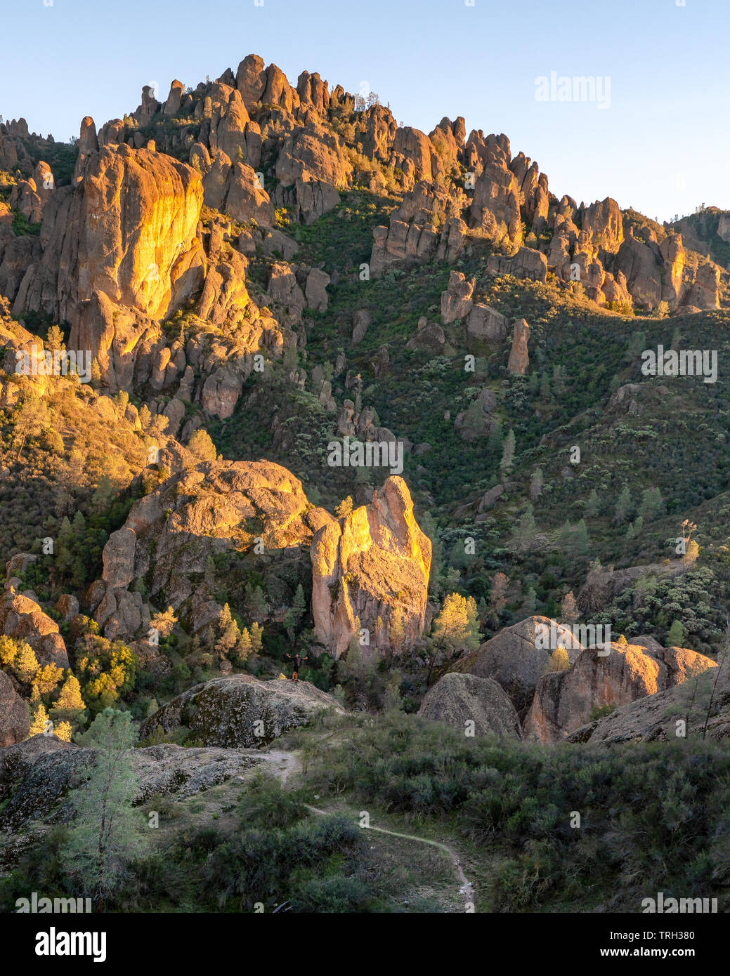 Hiker on the edge of an overlook on a trail in Pinnacles National Park ...
