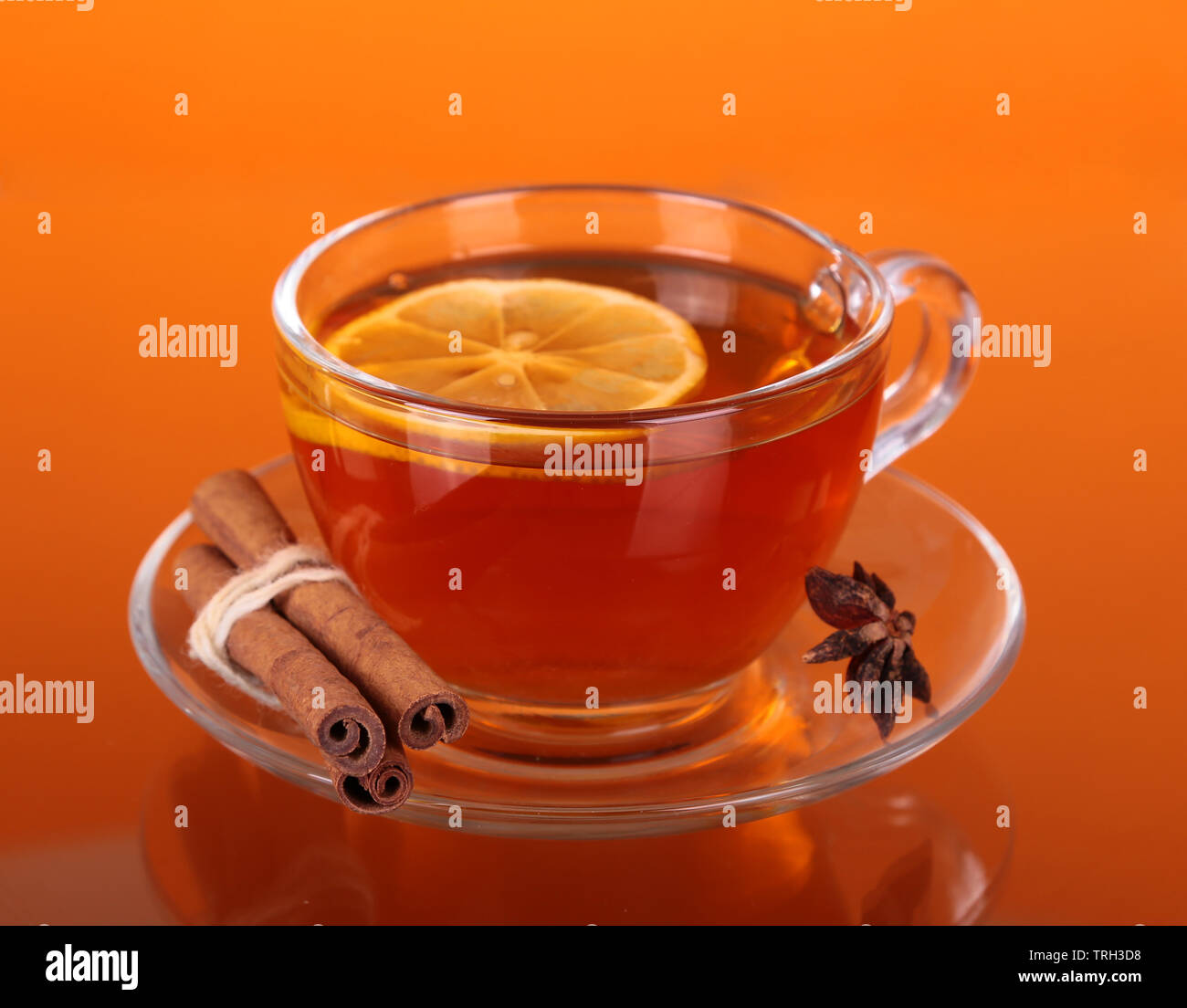 Glass cup of tea on an orange background Stock Photo - Alamy