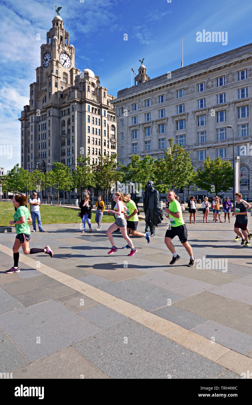 Liverpool, UK. May 25th 2019. Runners in fancy dress costumes taking ...