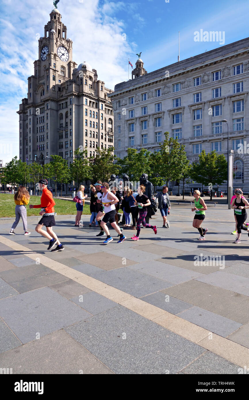 Liverpool, UK. May 25th 2019. Runners in fancy dress costumes taking ...