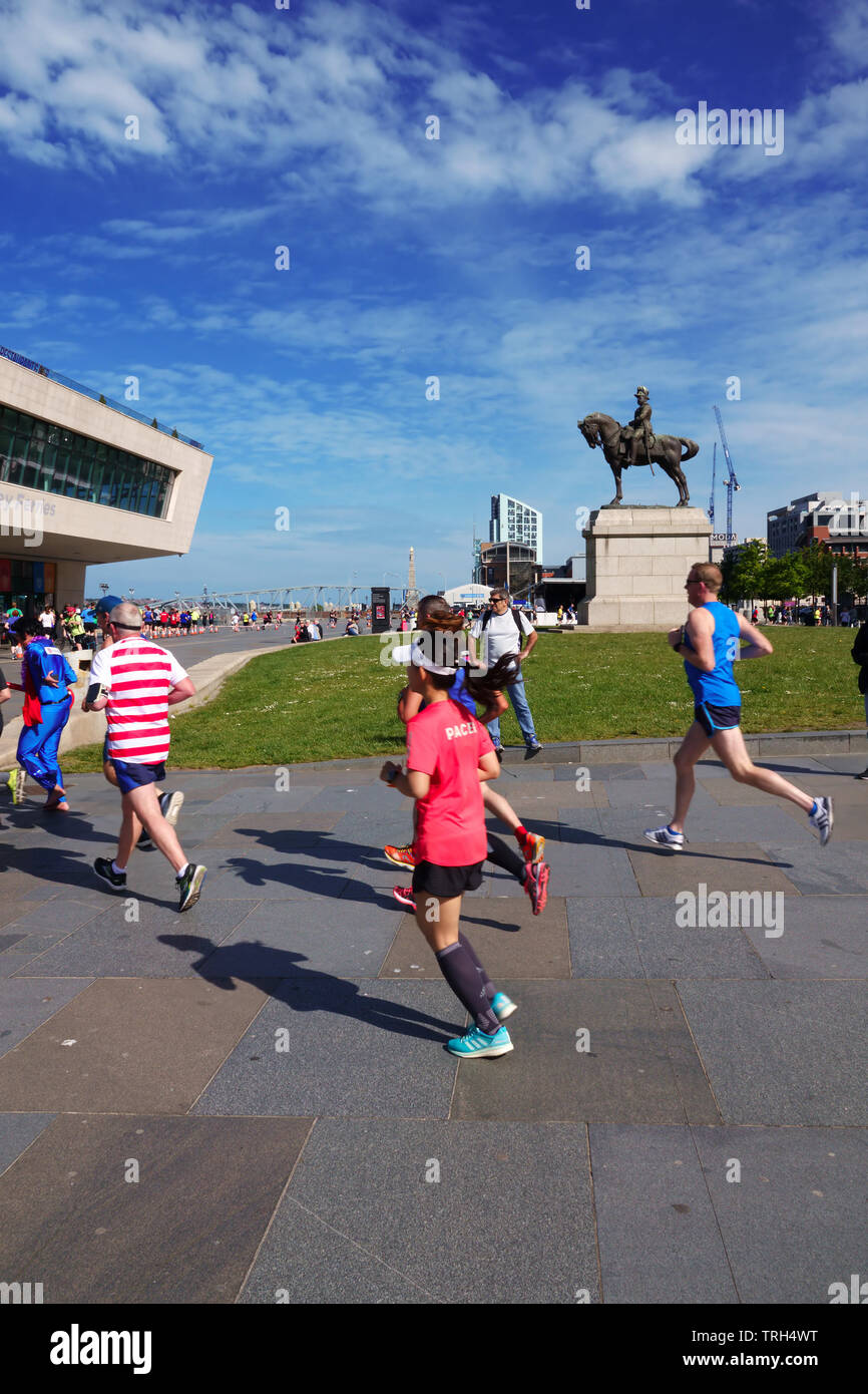 Liverpool, UK. May 25th 2019. Runners in fancy dress costumes taking ...