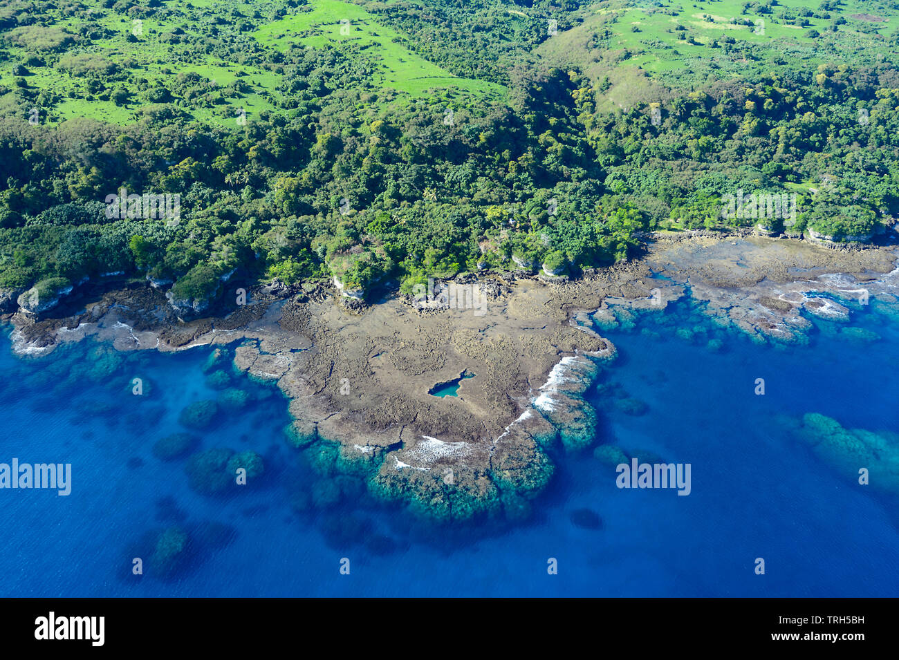 Aerial view of the coastline of Tanna Island showing coral reef ...