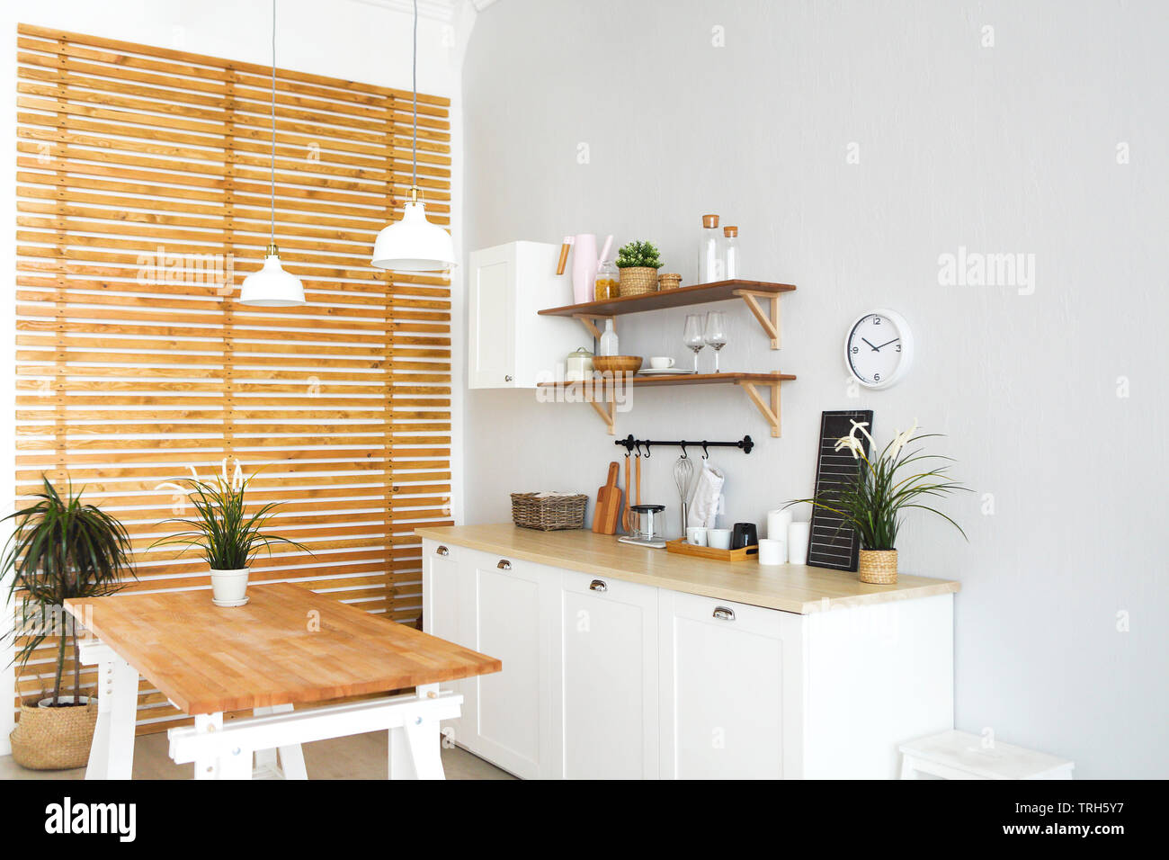 Interior of empty modern white kitchen with various objects on the ...