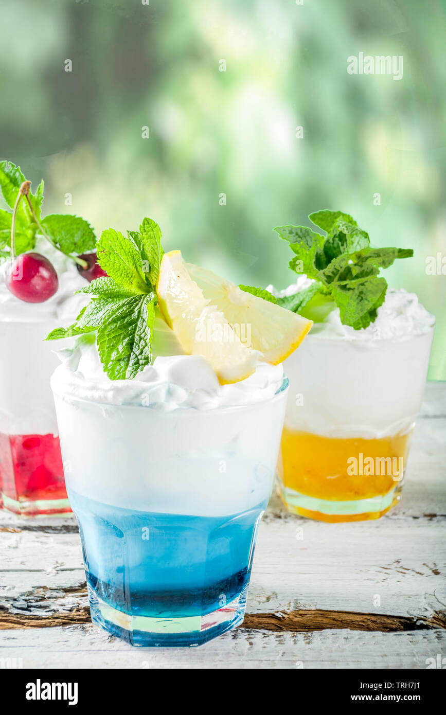 Summer cold drinks. Colorful Italian cream soda cocktails over white ...