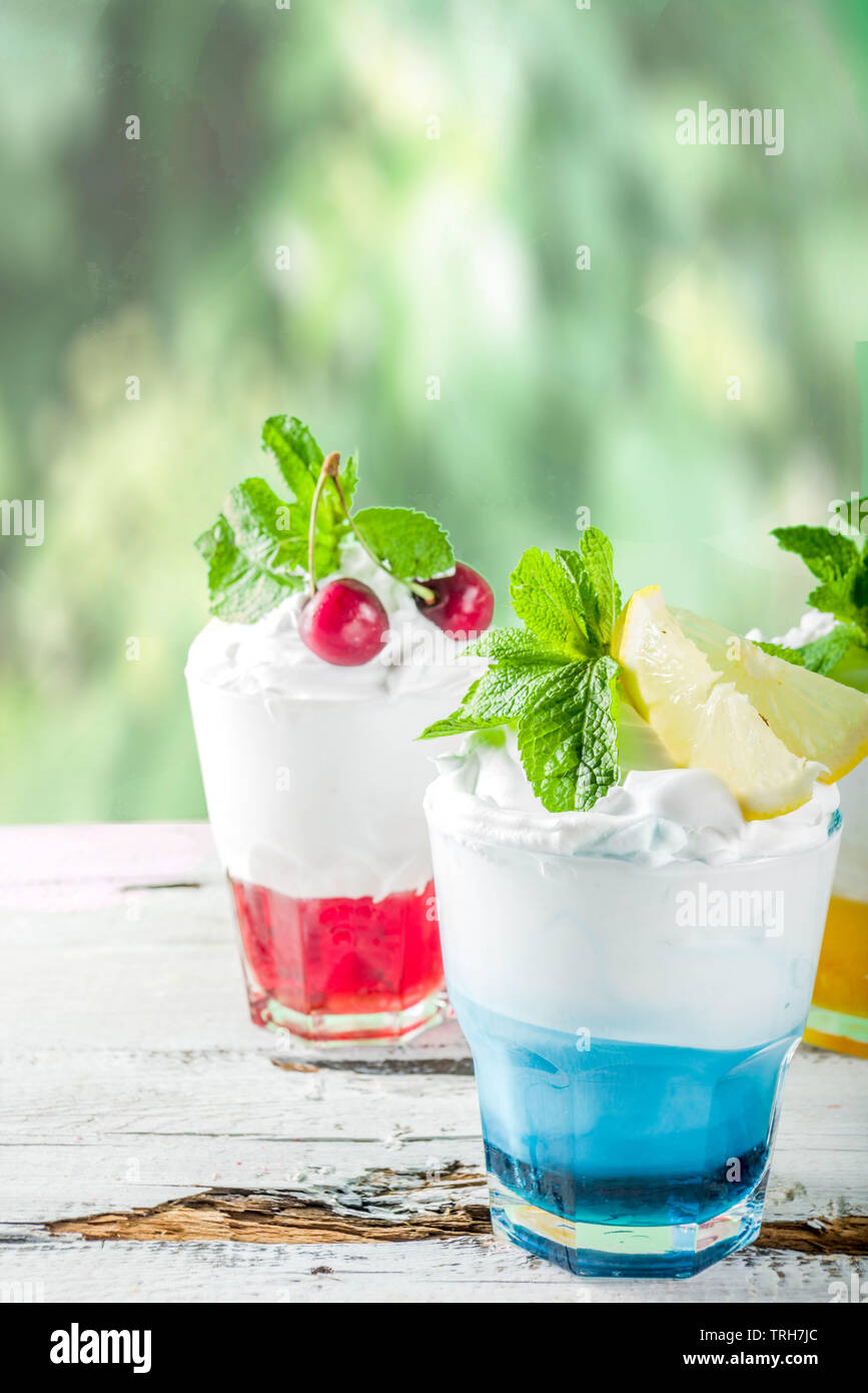 Summer cold drinks. Colorful Italian cream soda cocktails over white ...