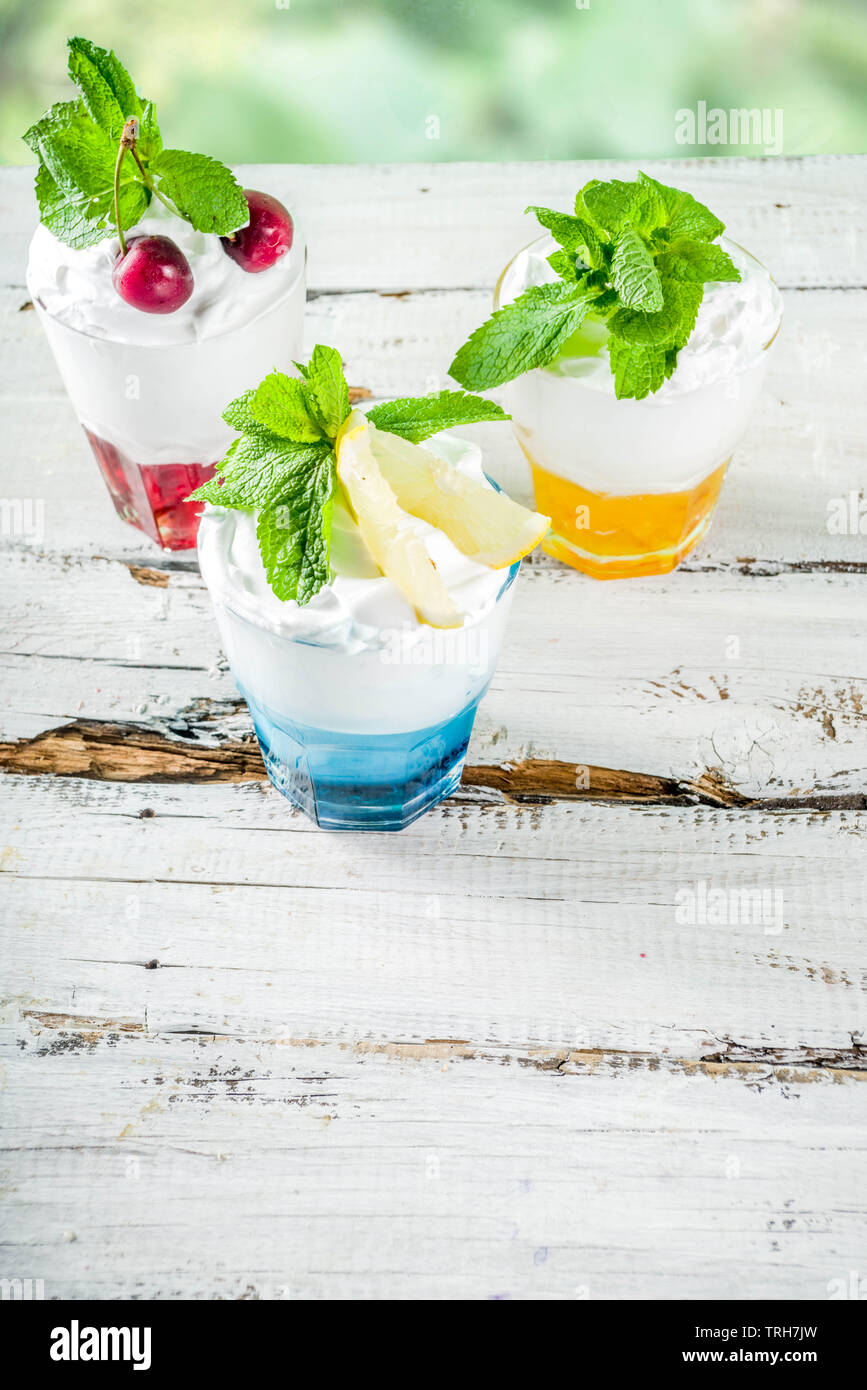 Summer cold drinks. Colorful Italian cream soda cocktails over white ...