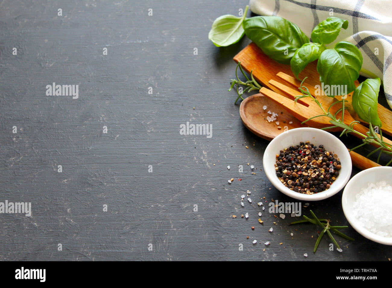 Wooden spoon and knife with ingredients on dark background. Top view ...