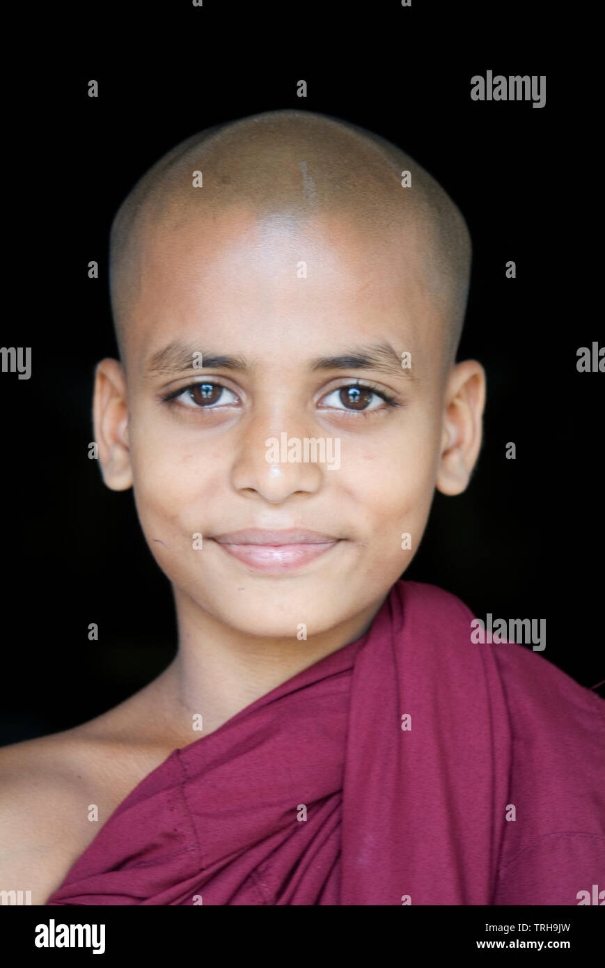 A young monk at the Dambulla Cave Temple in Sri Lanka. Dambulla is the ...