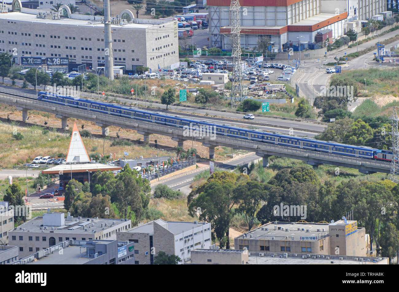 Passenger train passes through the industrial zone of Haifa Bay, Israel ...