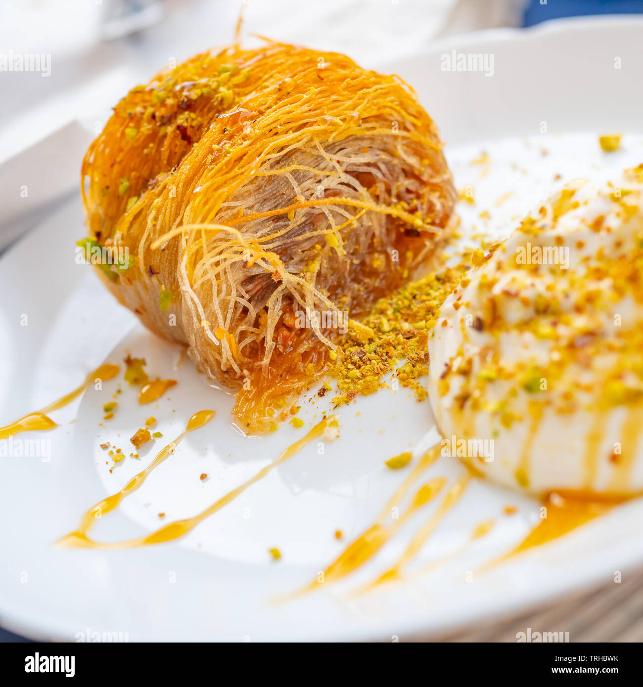 Close up of a succulent Greek dessert. Greek kataifi with honey yogurt ...