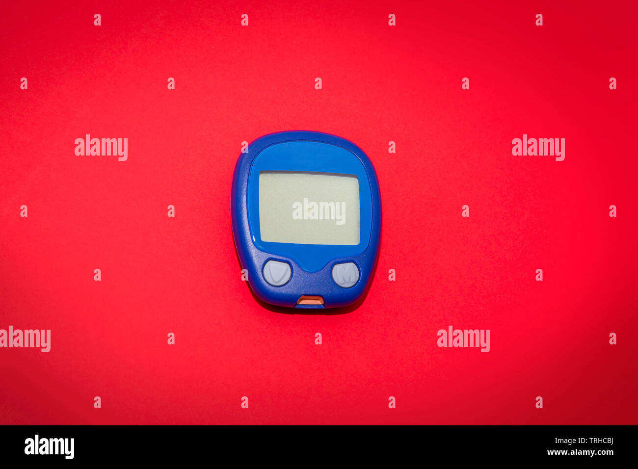 Blank glucometer on red background. Diabetes concept Stock Photo - Alamy