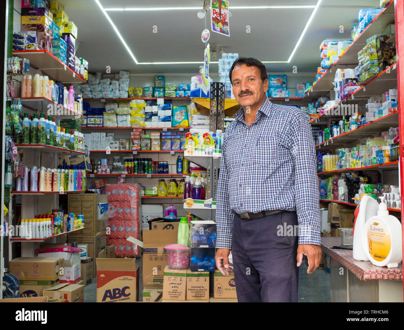 A man stands inside the door of his shop in Varzaneh, Iran Stock Photo ...