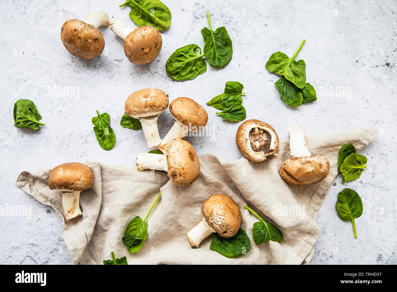 Champignon mushrooms on concrete background Stock Photo - Alamy