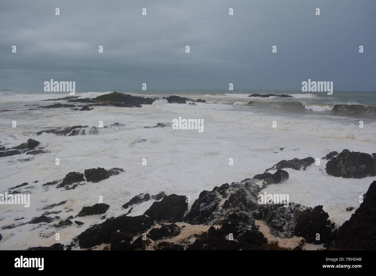 Foamy frothy white sea water after the storm, waves crashing over the ...