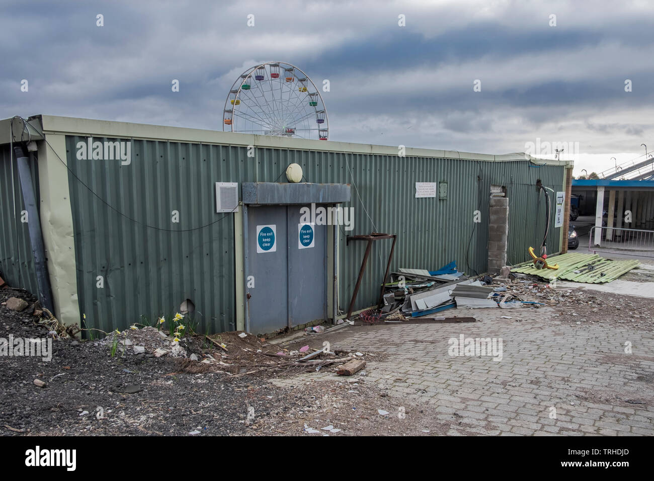 Run down office building, made of green corrugated iron, with rubbish ...