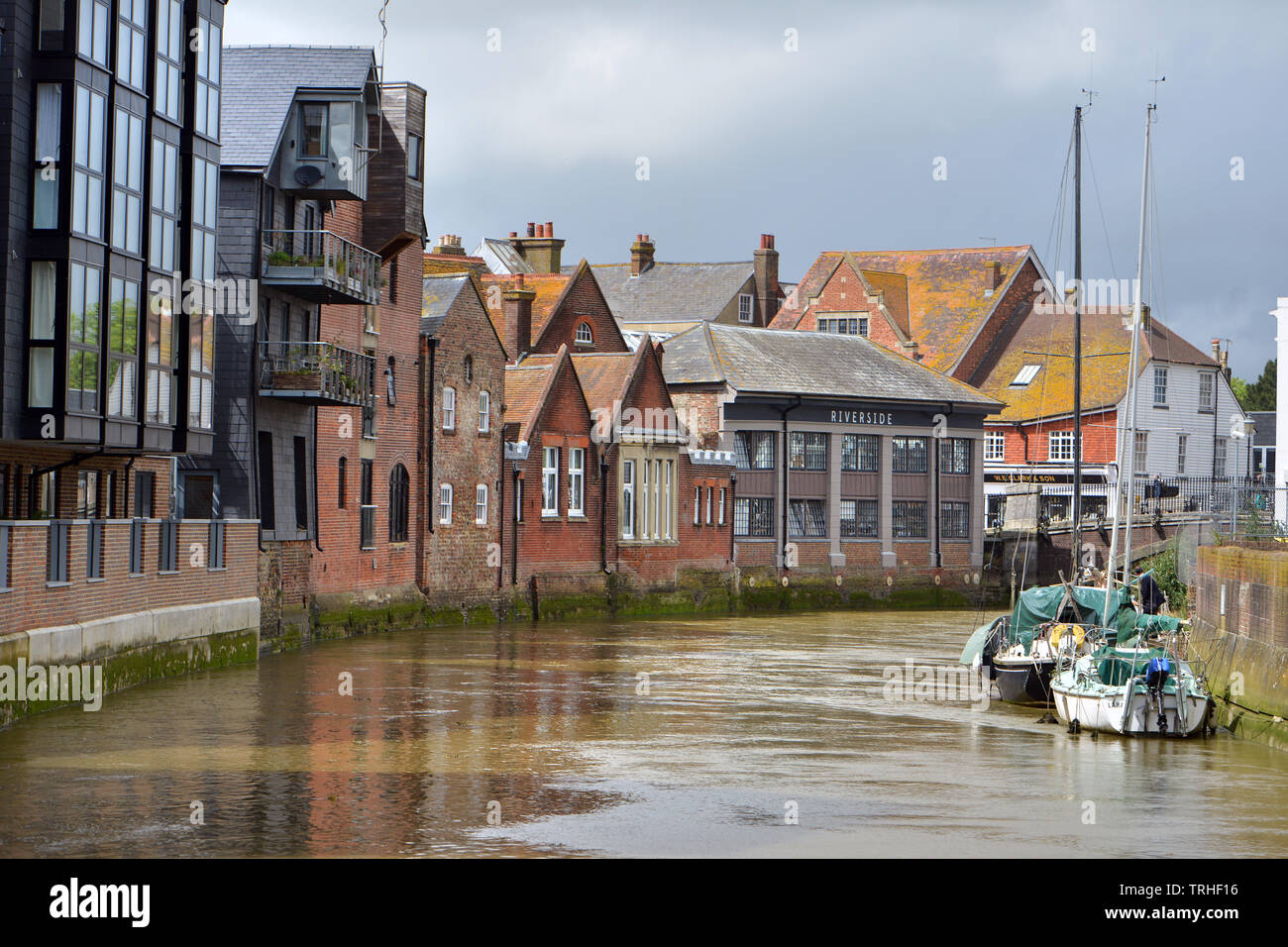 Historic waterfront in Lewes, with the tidal Ouse river flowing by ...
