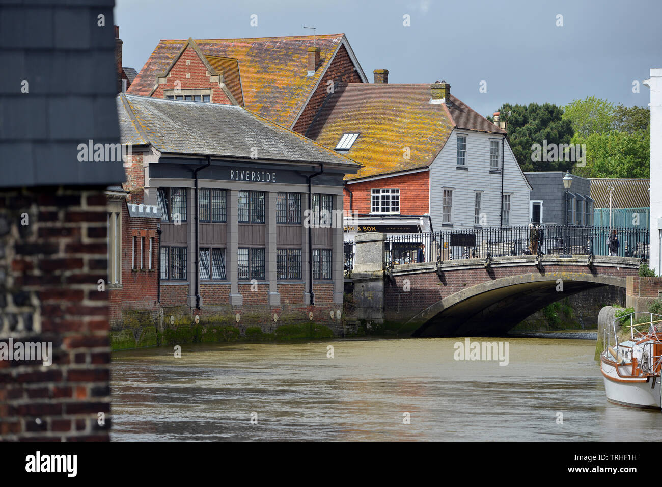 Historic waterfront in Lewes, with the tidal Ouse river flowing by ...