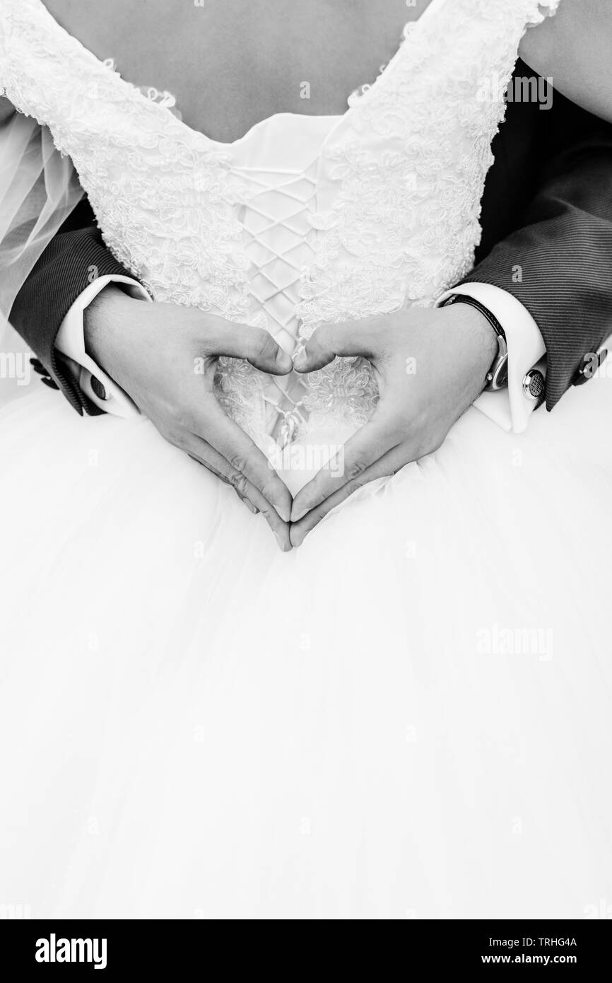 The groom was wrapped in the bride, the groom's hands had a heart Stock ...