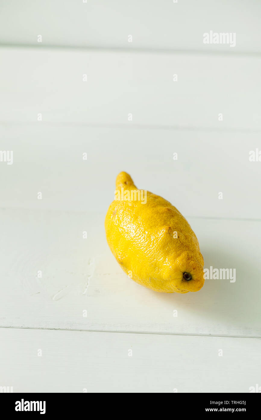 Trendy ugly organic lemon unusual shape on white background with copy ...