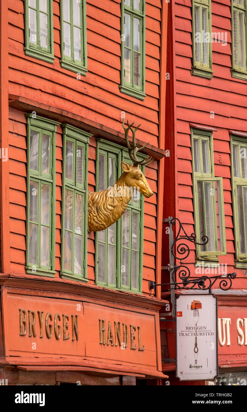 Colorful wooden figure of a golden deer Golden deer on the wall of a ...