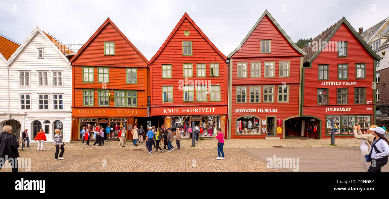 Tourists walking on a large paved square against the backdrop of ...