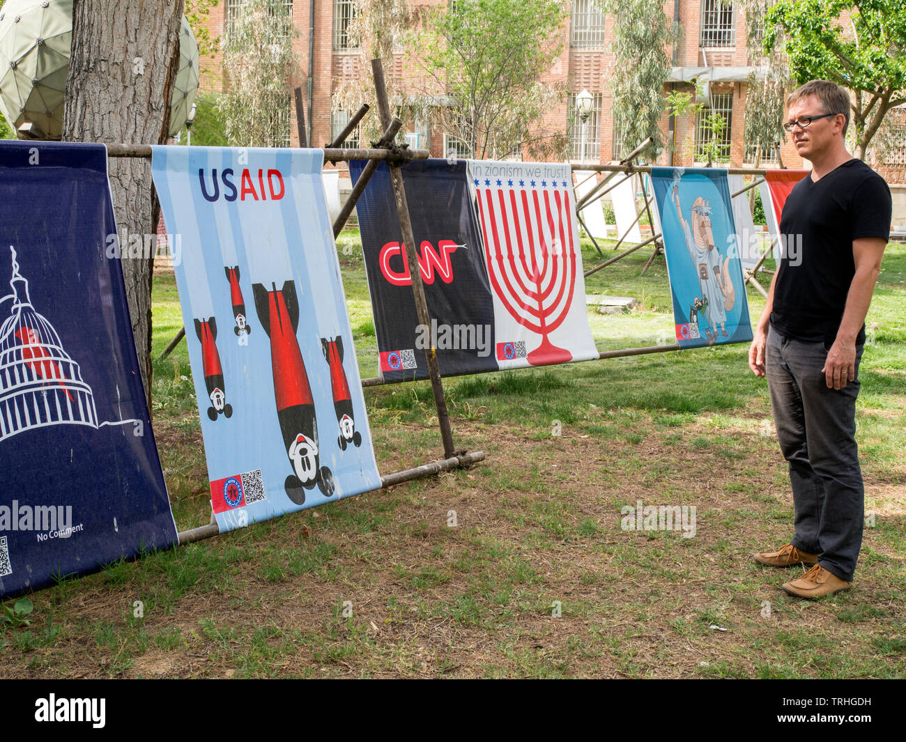 A European tourist looks at propaganda posters at the Museum Garden of ...