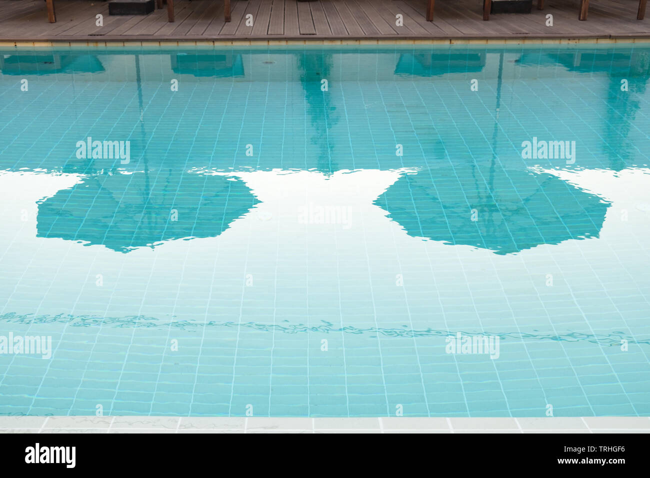 Swimming pool reflection shadow umbrella Stock Photo - Alamy