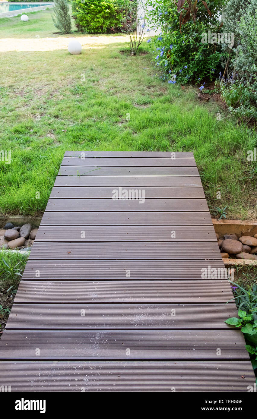 Wooden plank bridge walkway on lawn Stock Photo - Alamy