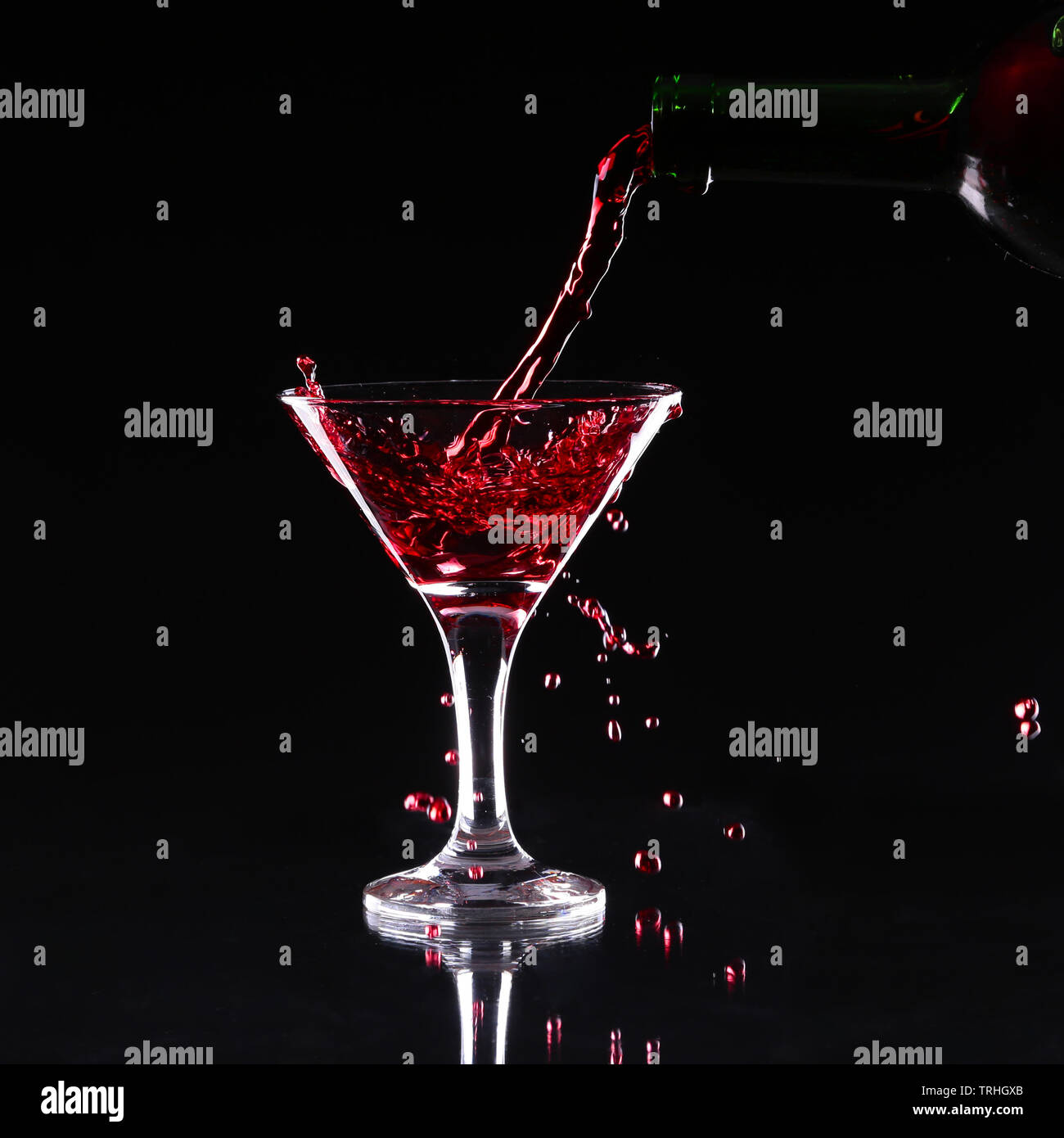 red splashing cocktail on black Stock Photo - Alamy