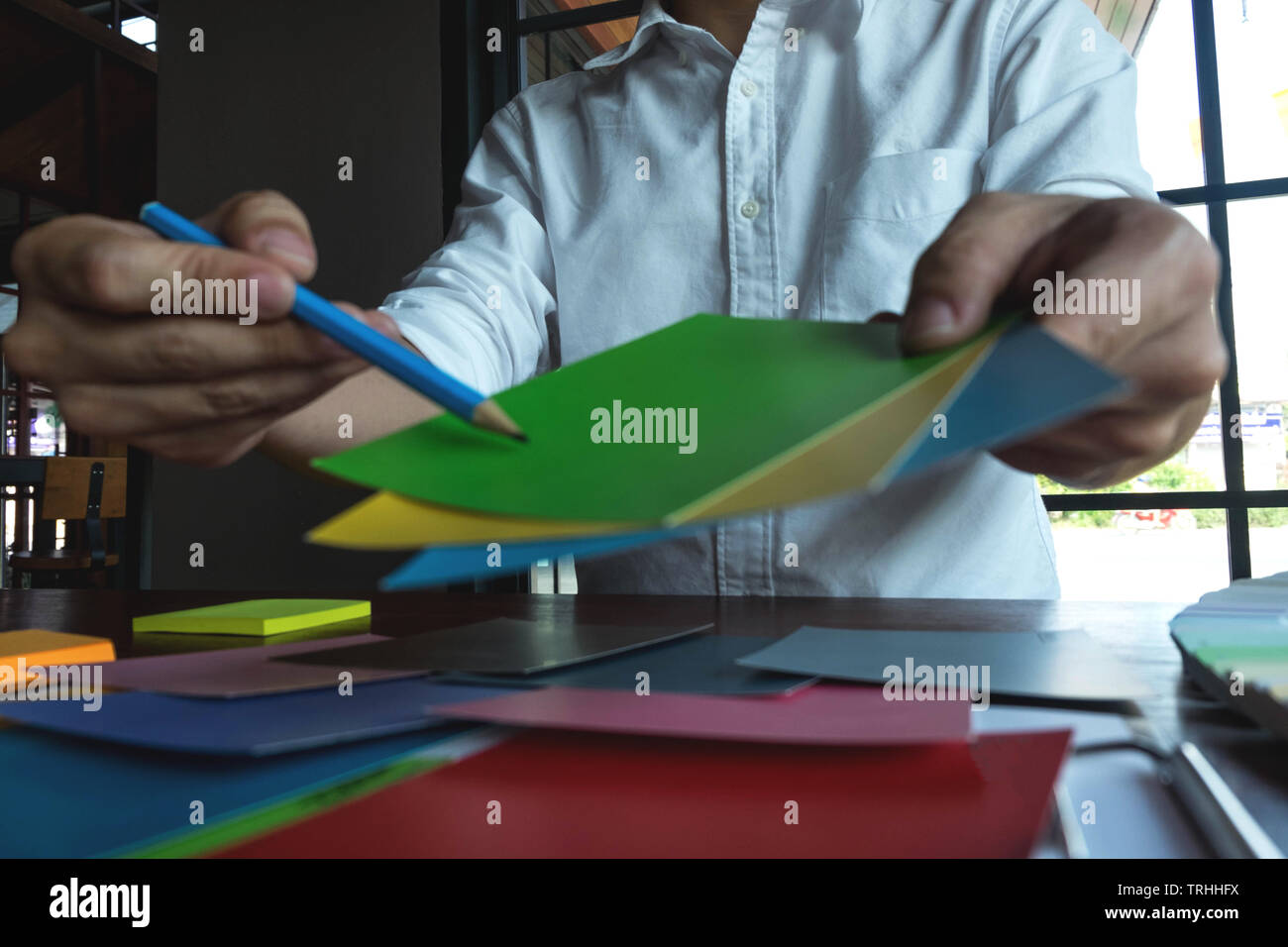 Graphic designer choose colors from the color bands samples for design ...