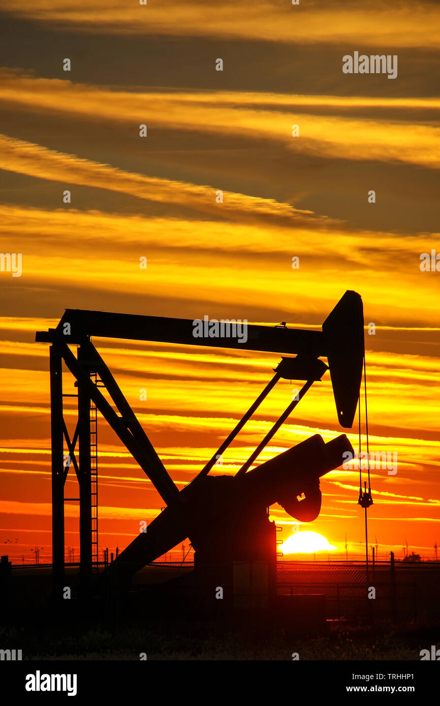 Silhouetted pump jack in the oil field at sunset Stock Photo - Alamy