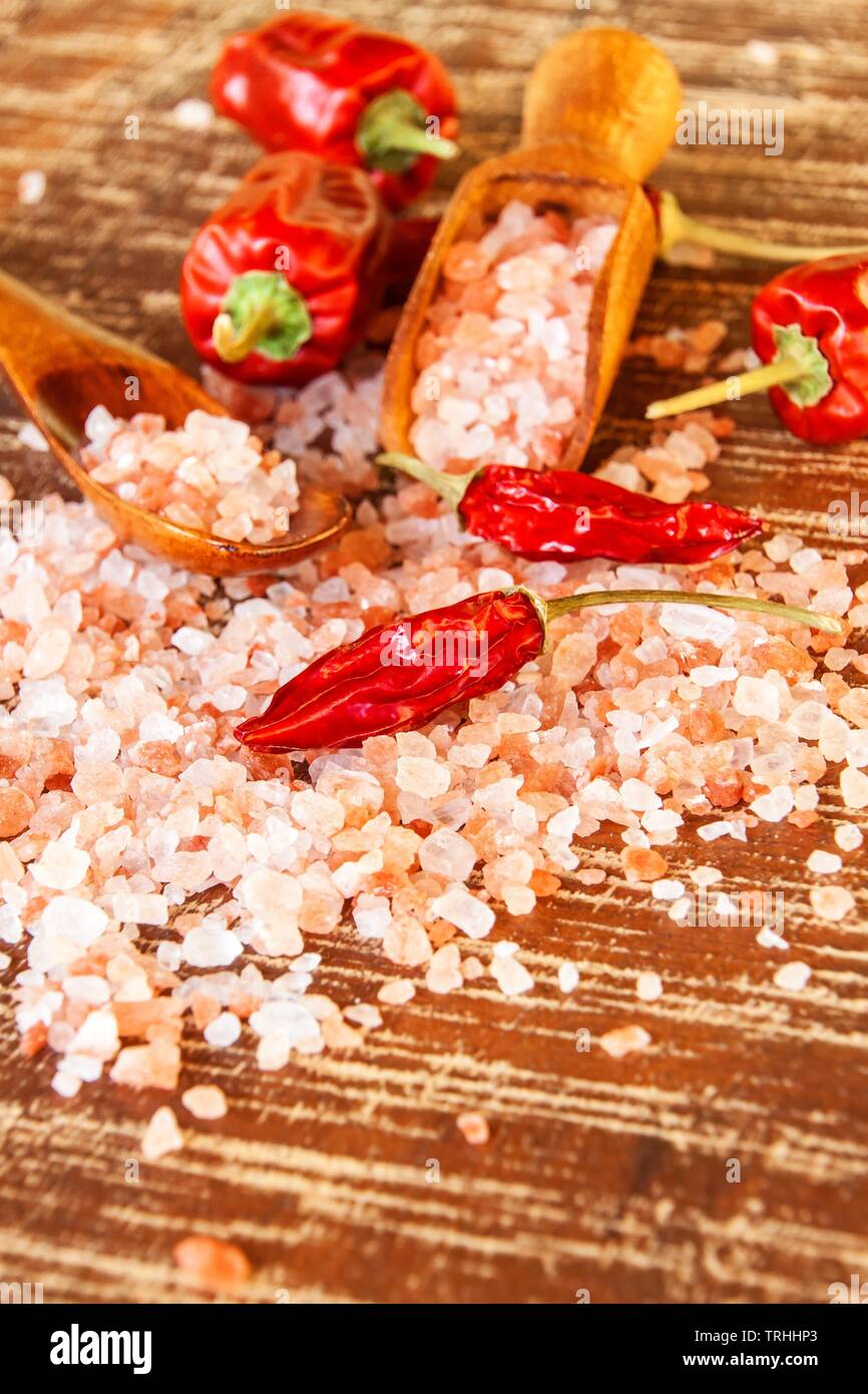 Himalayan pink salt. Kitchen salt and chili peppers. Spices on grill ...